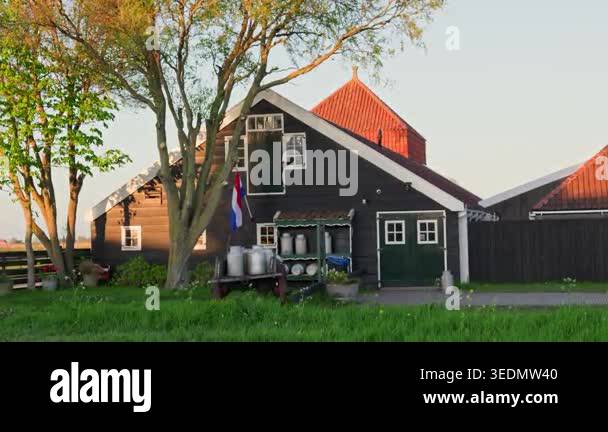 Traditional Dutch farmhouse in Netherlands countryside at sunset, rural ...
