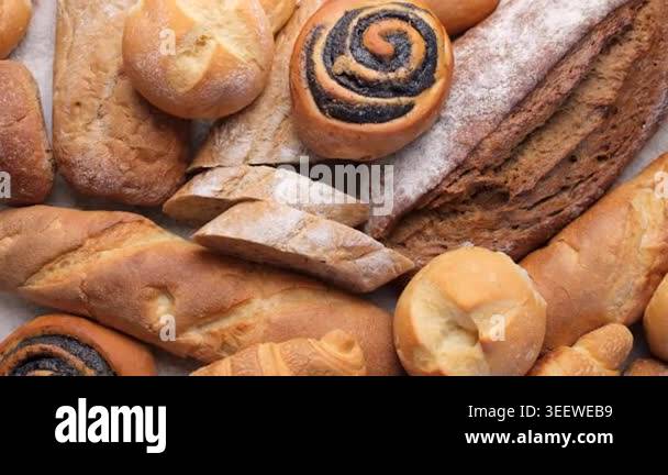 Variety of fresh bakery products including bread, buns, baguette, and ...
