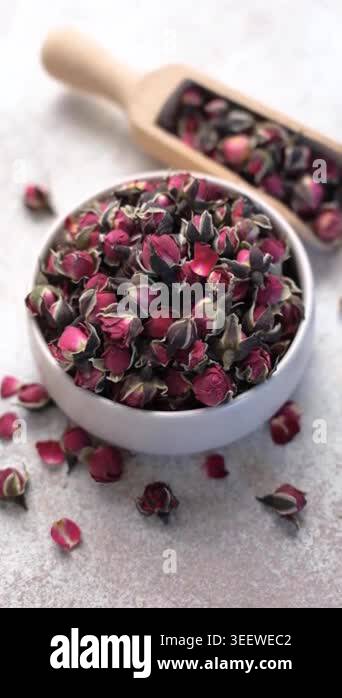 Dried rosebuds herbal tea rotating on a concrete background Stock Video ...