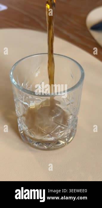 Fresh Cola Being Poured In To The Glass With Ice Cubes On White ...