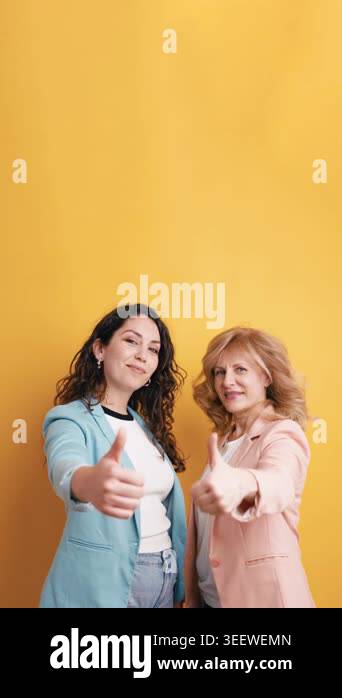 Happy mother and daughter business partners showing thumbs up ...
