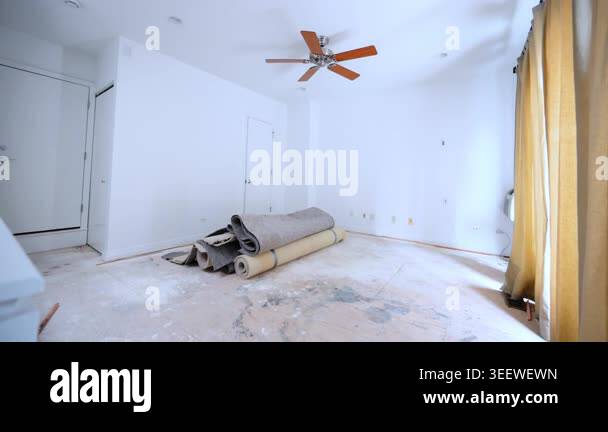 Empty room during home renovation with old carpet removed and ...
