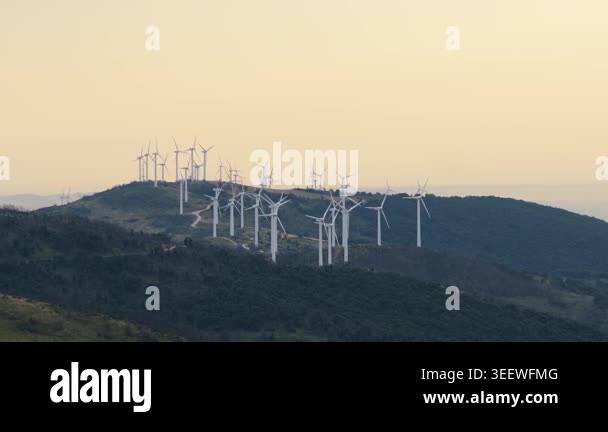 Wind turbines generating renewable energy on a verdant hillside. Clean ...