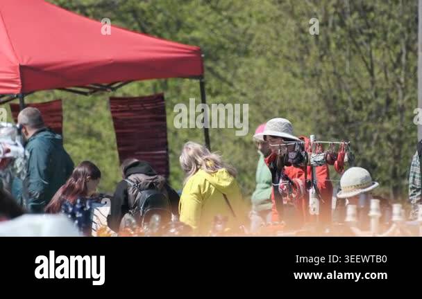 Lively market atmosphere with people exploring colorful stalls on a ...