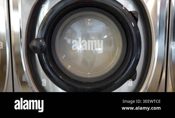 Close view of a front load washing machine door during a wash cycle ...