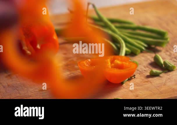 Preparing sliced orange pepper vegetables medium 4k slow motion shot ...