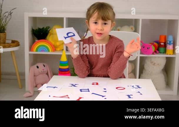 The child learns English letters. Selective focus. Kid Stock Video ...