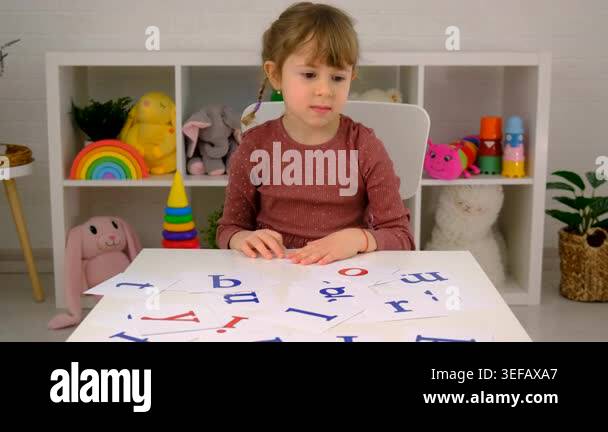 The child learns English letters. Selective focus. Kid Stock Video ...