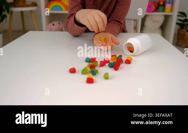 A child eats vitamin gummy bears. Selective focus. Kid Stock Video ...