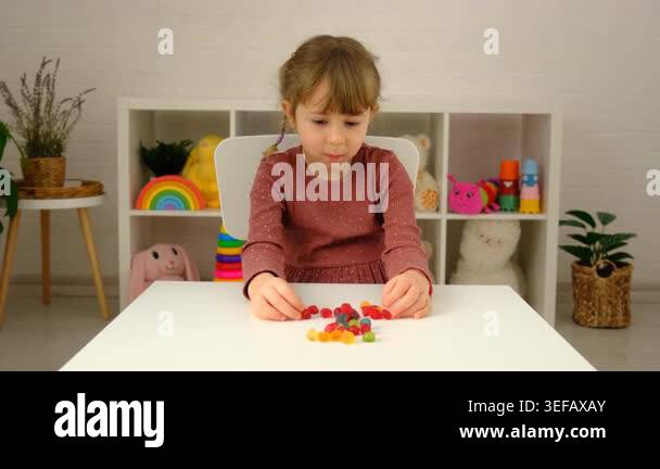 A child eats vitamin gummy bears. Selective focus. Kid Stock Video ...