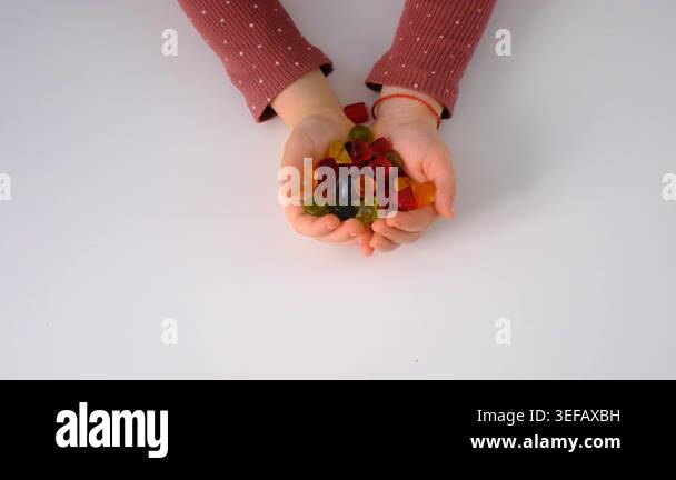 A child eats vitamin gummy bears. Selective focus. Kid Stock Video ...