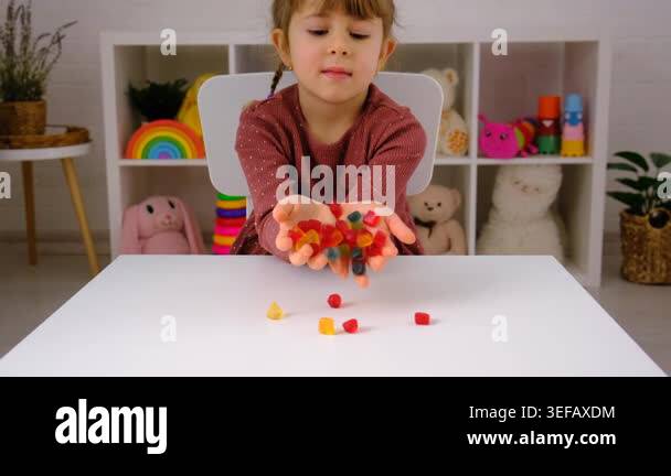 A child eats vitamin gummy bears. Selective focus. Kid Stock Video ...