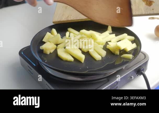 Crisp apple slices are added to a hot skillet, perfect for various ...