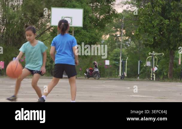 Active students practicing basketball drills during physical education ...