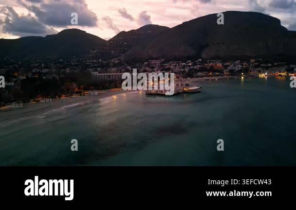 Coastal town in Sicily, Italy, features illuminated buildings along the ...
