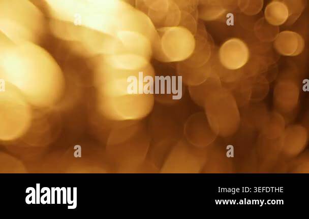 Abstract golden bokeh circles blur and glow, creating a beautiful light ...