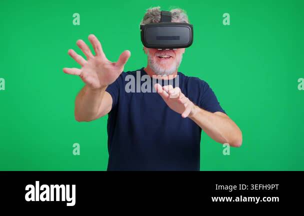 Amazed mature man wearing a virtual reality headset is touching ...