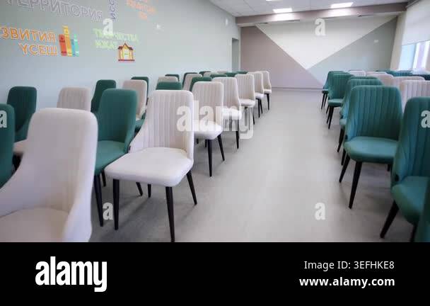 Rows of elegant teal and cream upholstered chairs organized for ...