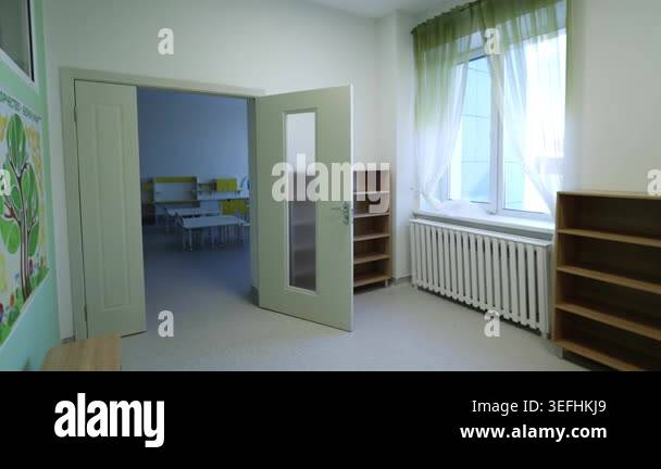 Large window with light curtains illuminates clean linoleum floor ...