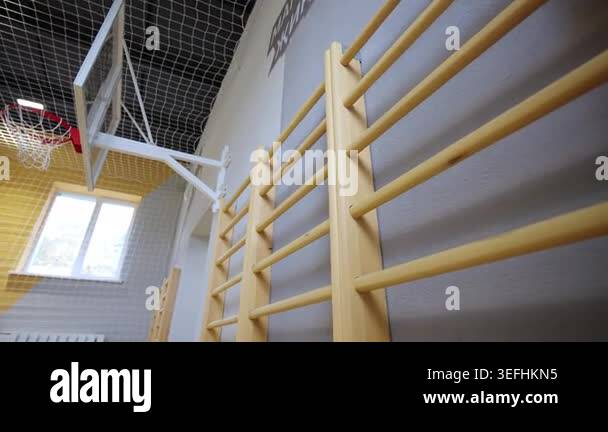 High ceiling gymnasium interior shows sports nets and polished wall ...