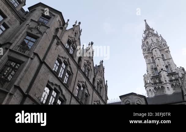 A low angle shot looking up at the intricate stone carvings, windows ...