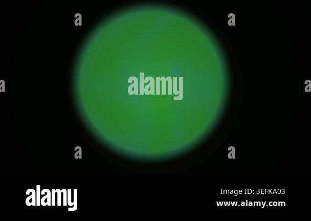 An abstract visual effect featuring a glowing green circular light ...