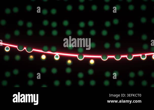 A high energy laser beam travels through a field of glowing green ...