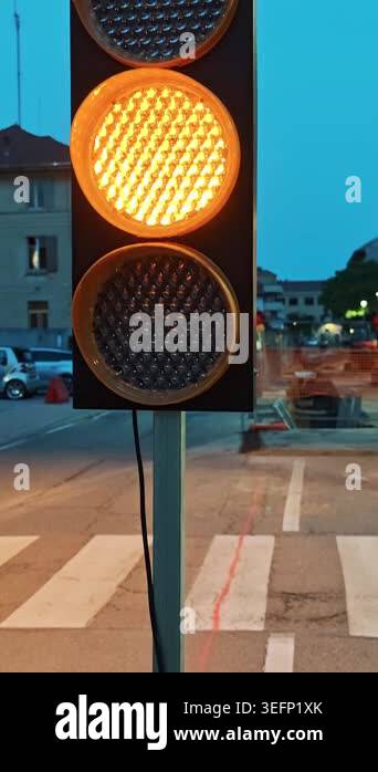 Illuminated amber signal warning drivers and pedestrians about road ...