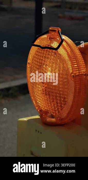 Bright yellow warning light securing street maintenance area. Essential ...