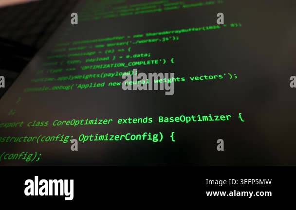 Green programming code lines stream across a dark screen with a glowing ...