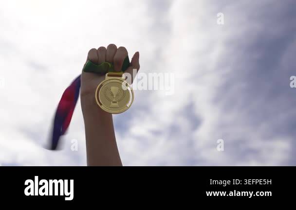 Gold Medal Raised Against Stormy Sky, Dramatic Clouds And Low Light ...