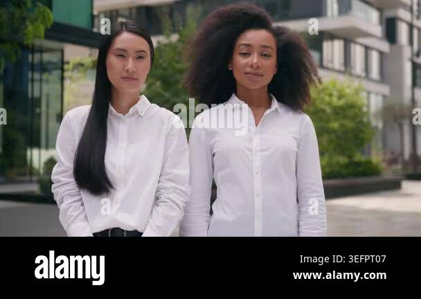 Two Asian Korean Chinese African American women businesswomen applause ...