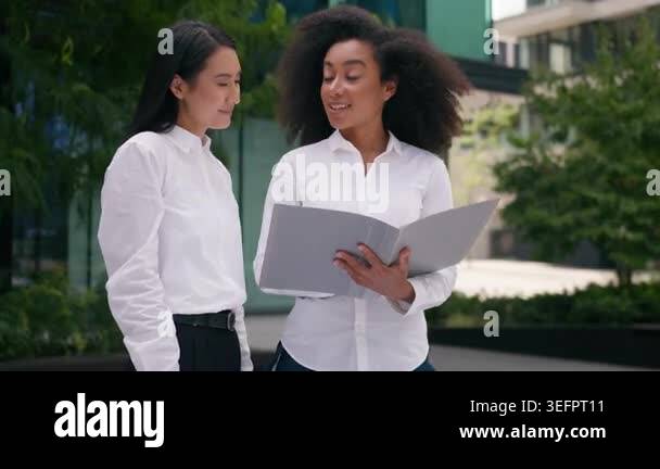 Friendly African American Asian Korean business women two colleagues ...