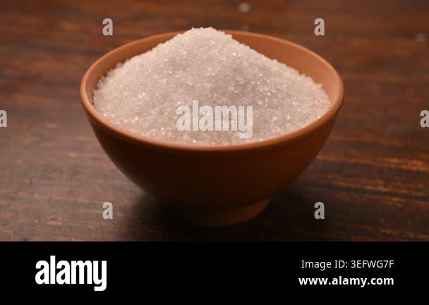 Minimal Cinematic Macro Shot of White Sugar in Spoon from Bowl on Table ...