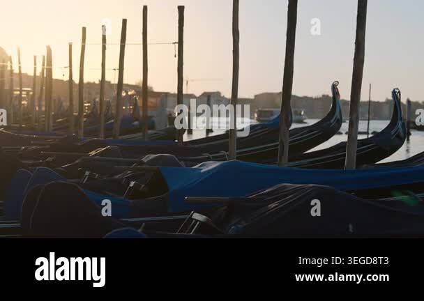 Traditional Venetian gondolas near pier in Venice. Historic ...