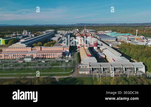 This aerial view shows a large aluminum factory with surrounding ...