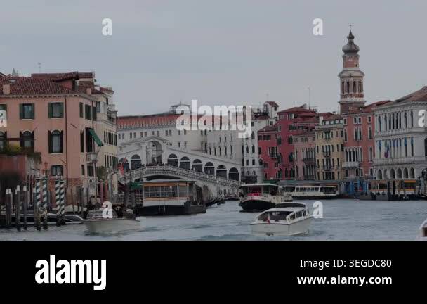 Peaceful Venice canal with gondolas, boats, historic facades, and soft ...