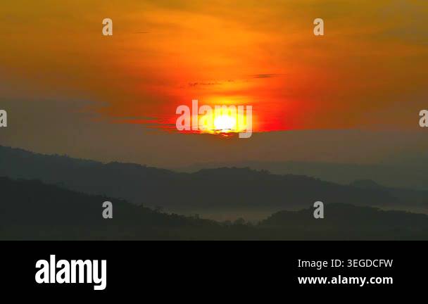 A stunning sunset paints the sky with vibrant orange and yellow hues ...
