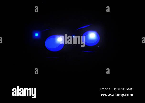 Abstract blue anamorphic lens flares moving on a black background ...