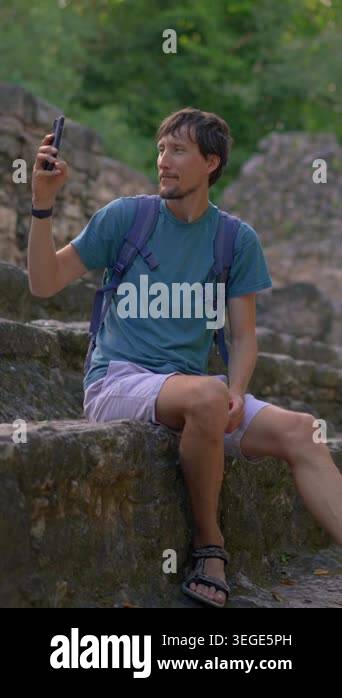 Young man tourist exploring ancient Maya ruins in Latin America ...