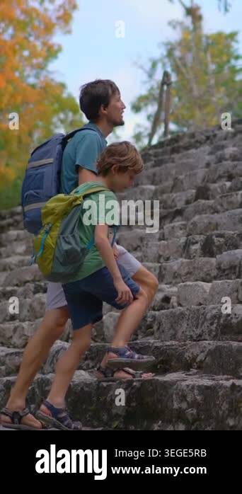 Young man and his son tourists exploring ancient Maya ruins in Latin ...