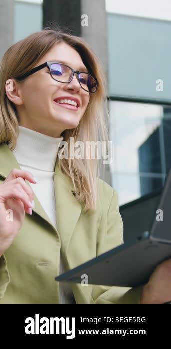 Portrait of happy young smiling woman in glasses talking on line in a ...