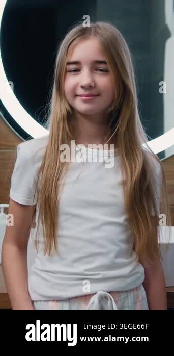 Portrait of smiling beautiful little girl in pajamas with long hair ...