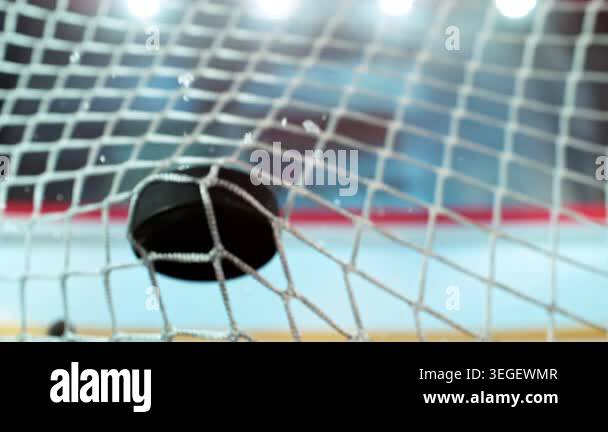 Super Slow Motion of Ice Hockey Puck Hitting the Back of the Net as it ...