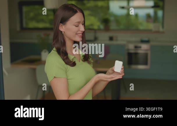 Happy Slow motion shot of a happy smiling young woman dispensing a ...