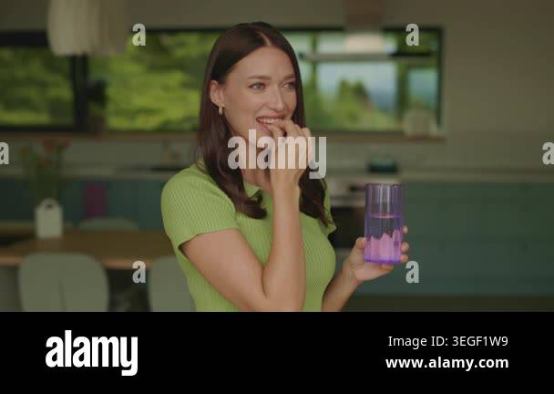 Slow motion shot with camera moving towards a happy smiling young woman ...