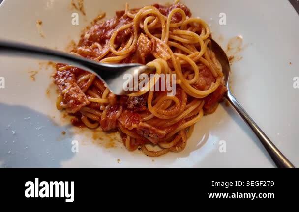 Detailed view of twirling spaghetti with tomato sauce and Parmesan on ...