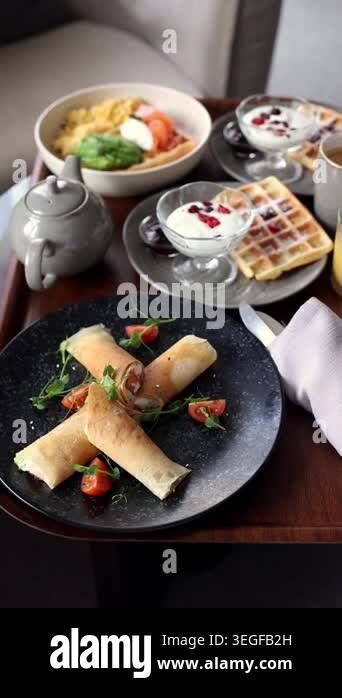 Elegant breakfast for two served in bed with coffee, tea and fresh ...
