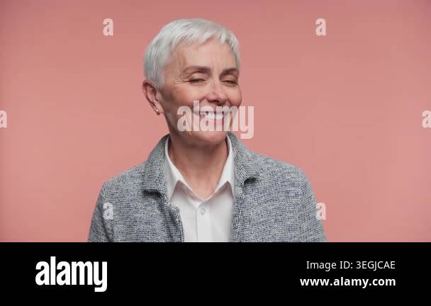 Portrait of a happy older woman with short gray hair smiling ...