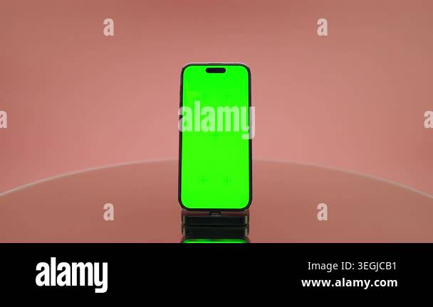 Modern smartphone on a stand with bright green chroma key screen, ideal ...